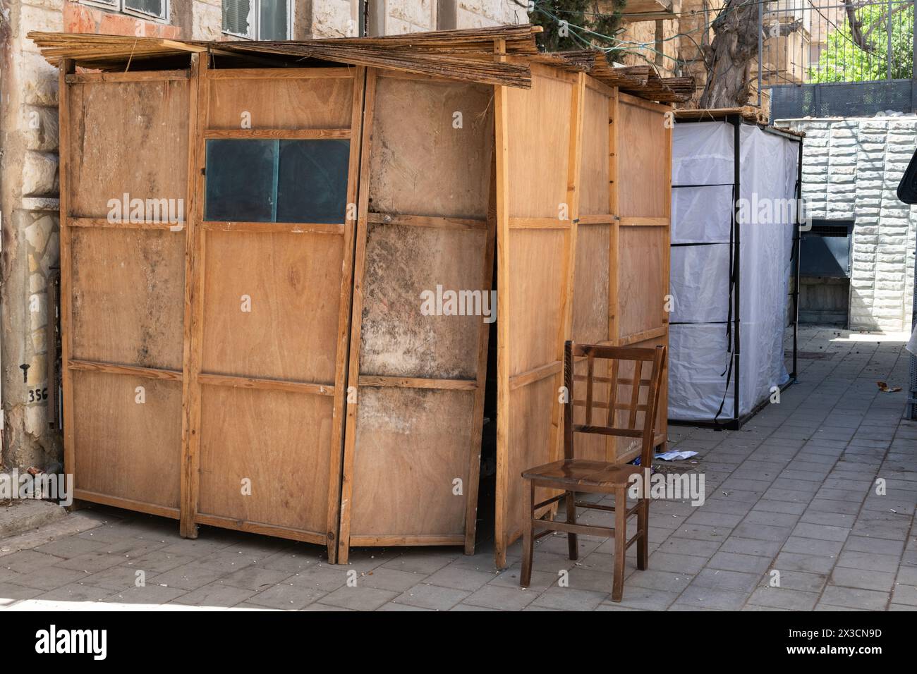 A street scene in Jerusalem during Sukkot, in which temporary, wooden ...