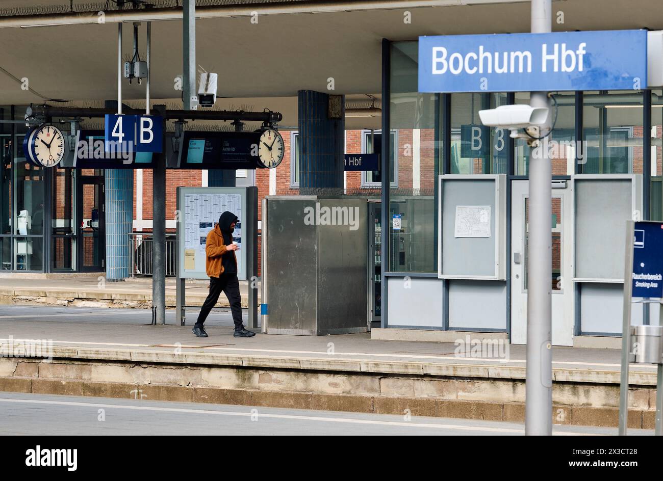 Bochum, Germany. 26th Apr, 2024. A train passenger walks across an empty platform at the main ...