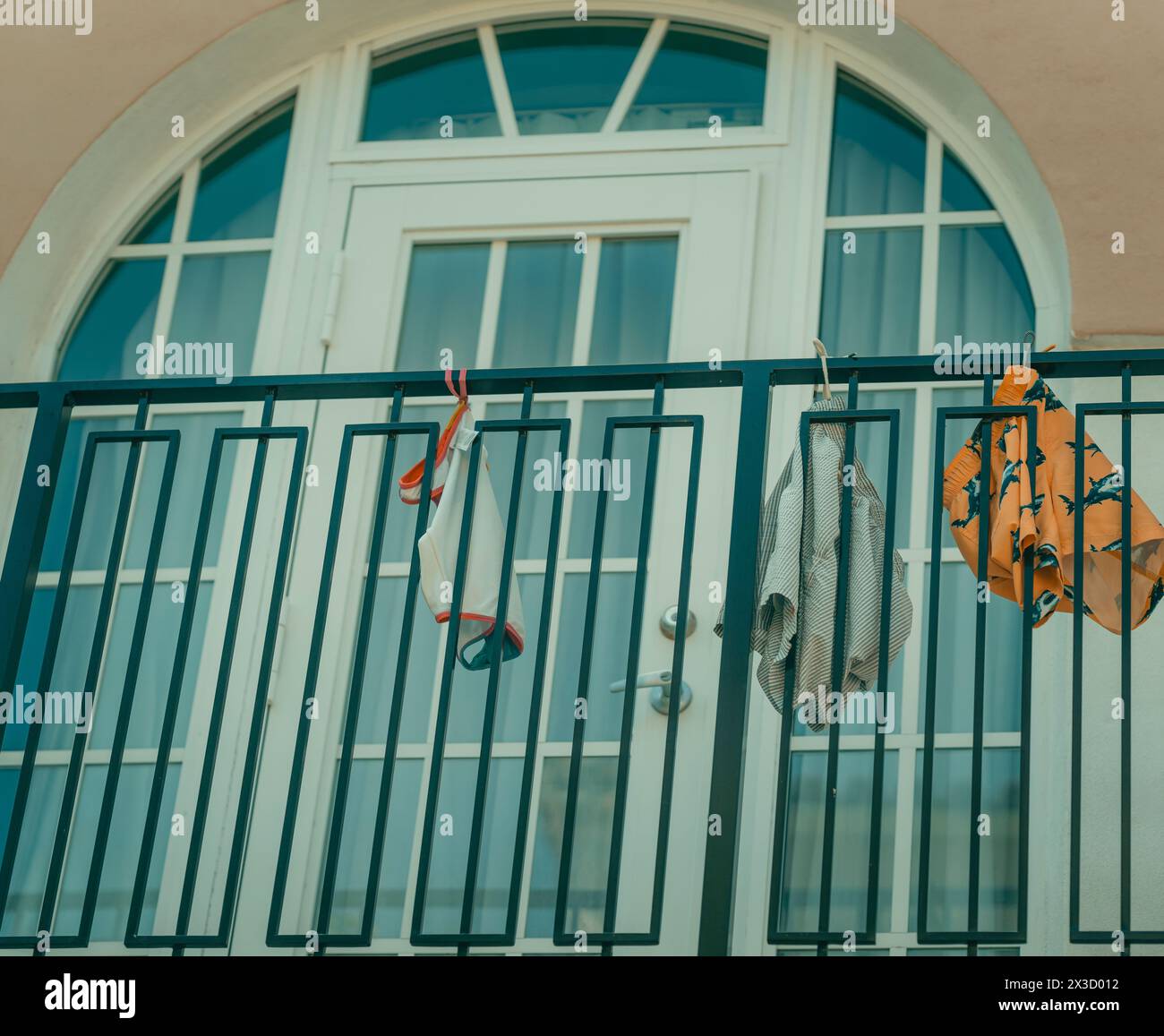 windows of a building balcony hanging clothes miami Stock Photo - Alamy