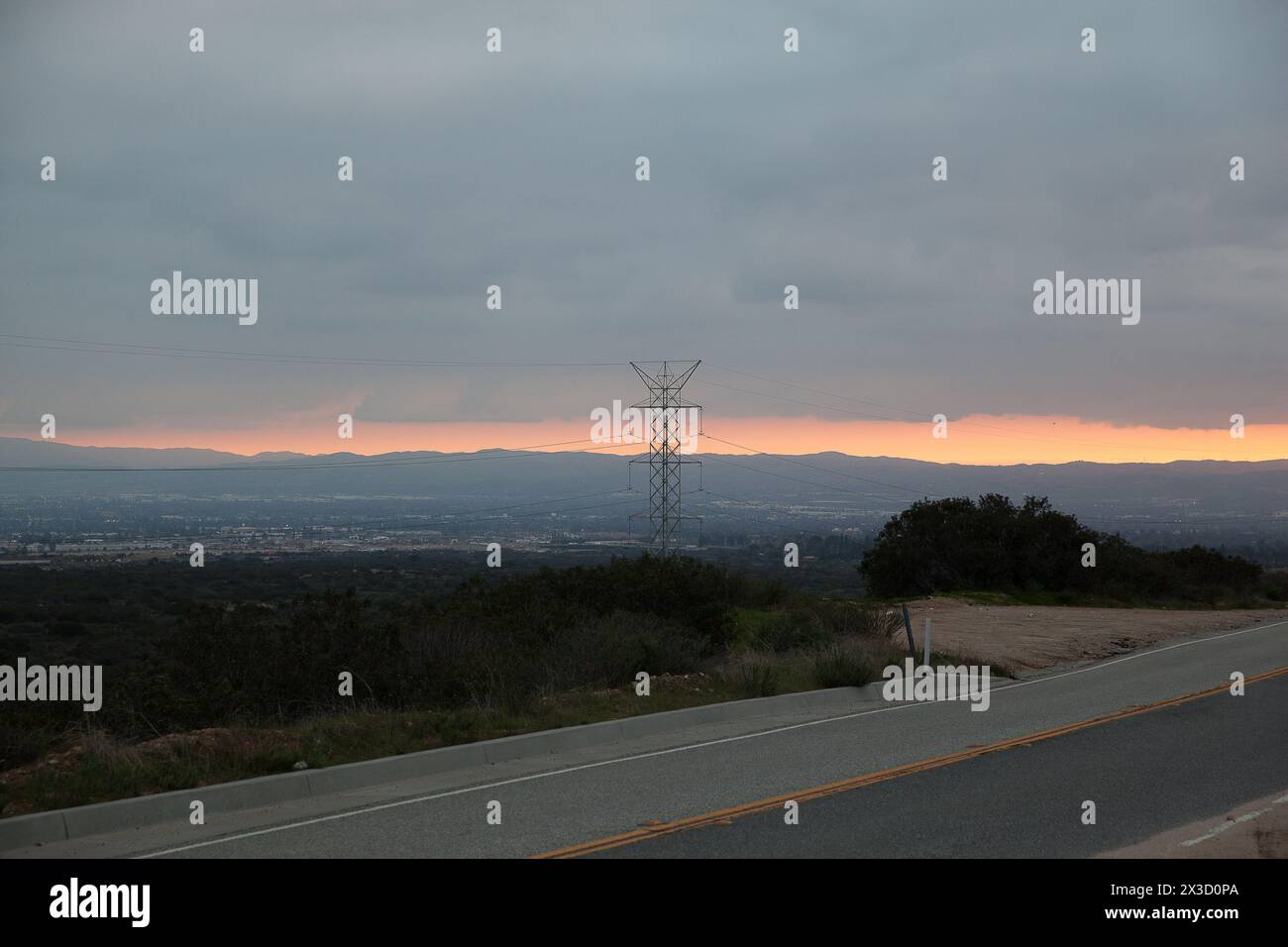 Dusk skyline view with silhouette of a powerline Stock Photo - Alamy