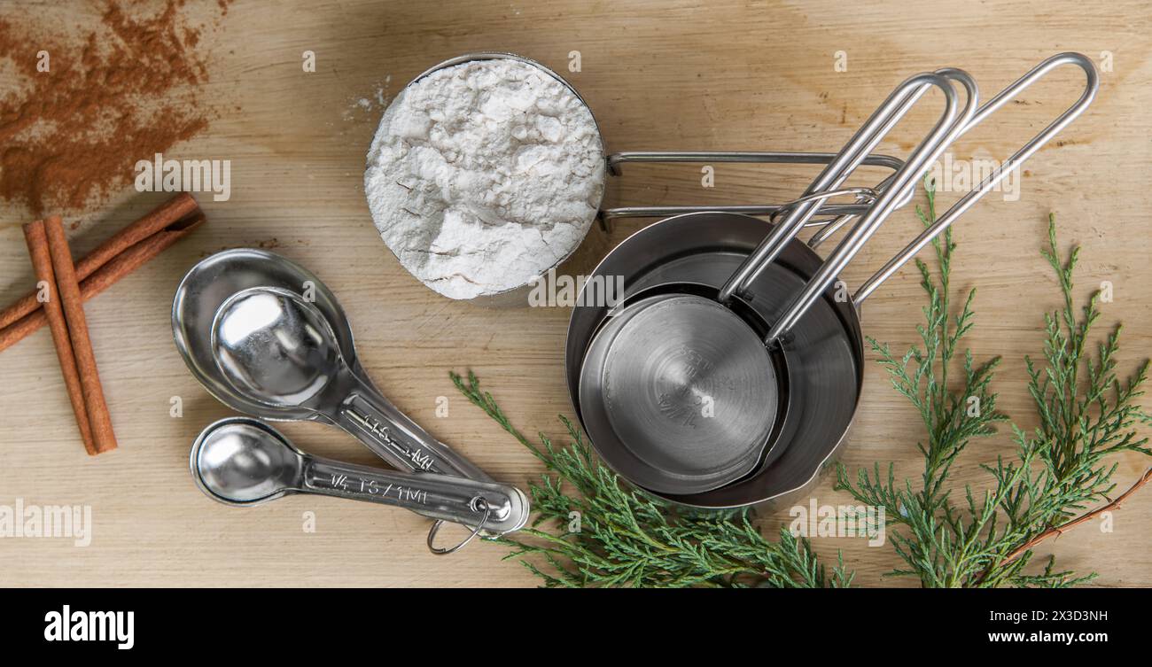 Stainless measuring tools and ingredients with festive greenery Stock ...