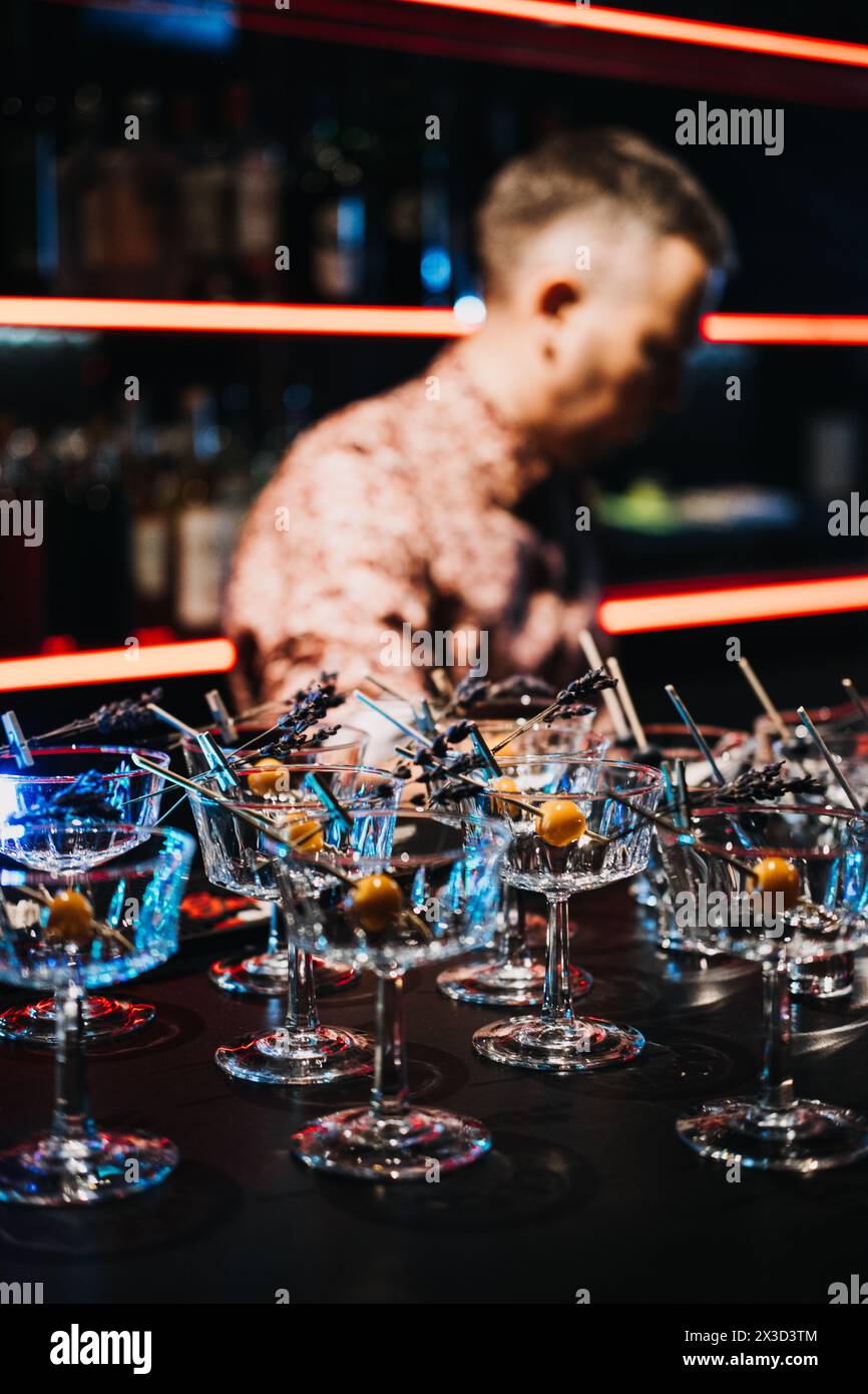 Bartender Crafting Cocktails at a Neon-Lit Bar Stock Photo - Alamy