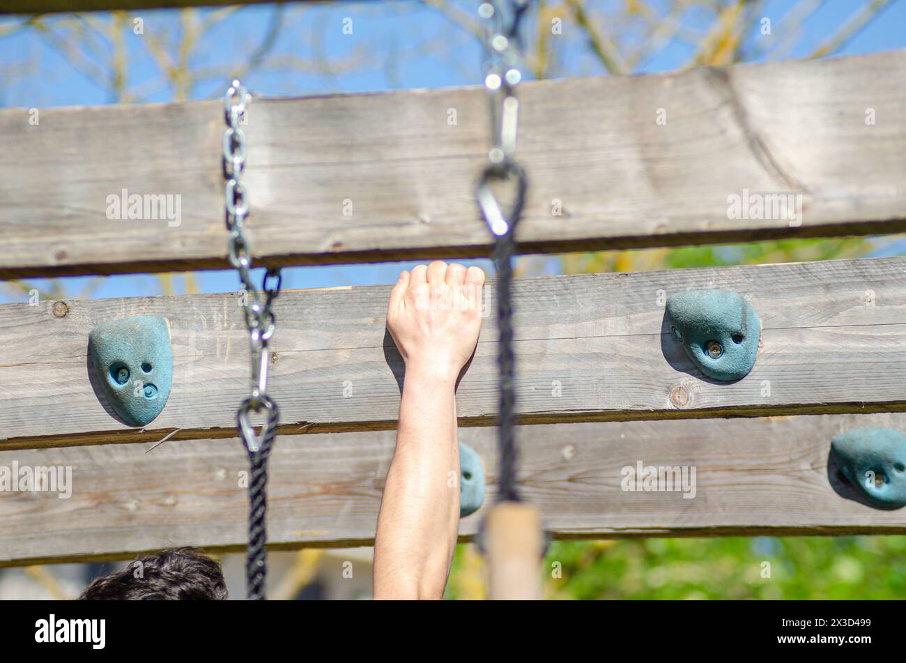 athlete hand at a hanging obstacle at an obstacle course race, OCR ...