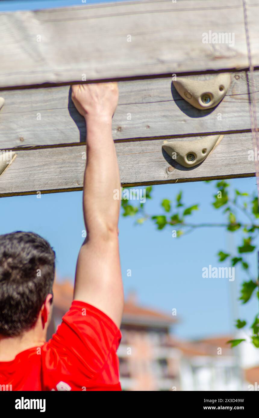 athlete hand at a hanging obstacle at an obstacle course race, OCR ...
