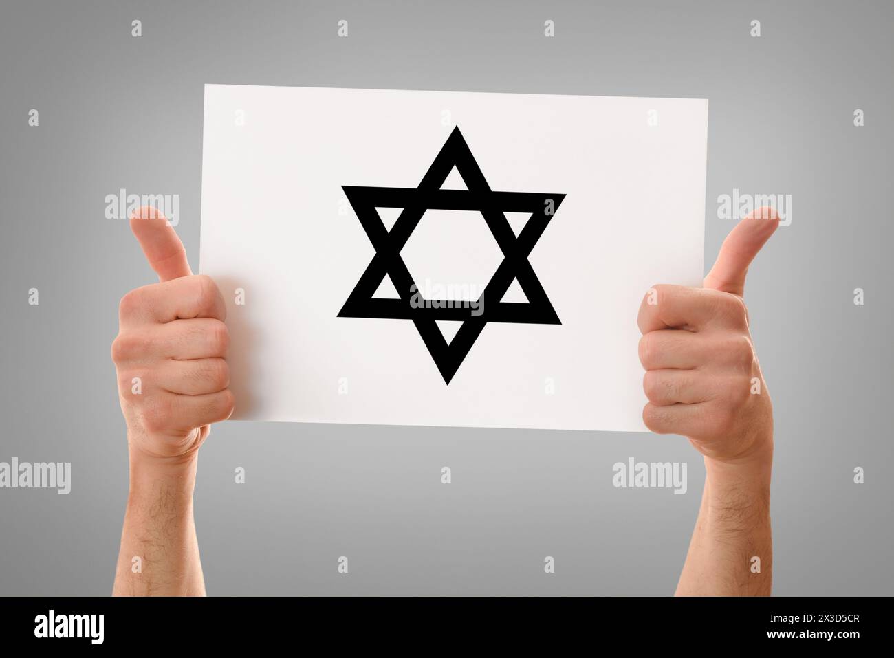 Hands of a religious man with okay sign holding a white poster with ...