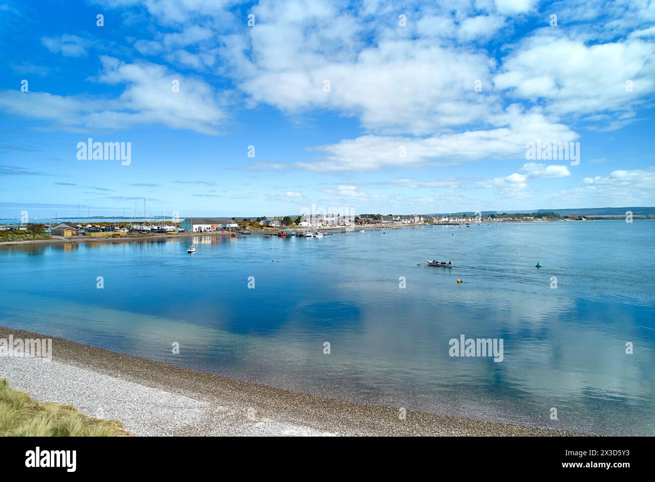Findhorn Moray Coast Scotland blue sky in Spring a rowing boat and calm ...
