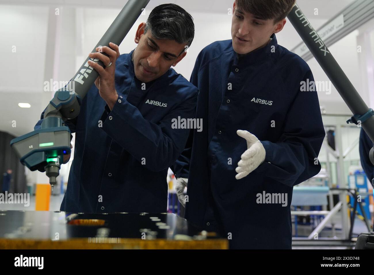 Prime Minister Rishi Sunak using machinery during a visit to the Airbus ...
