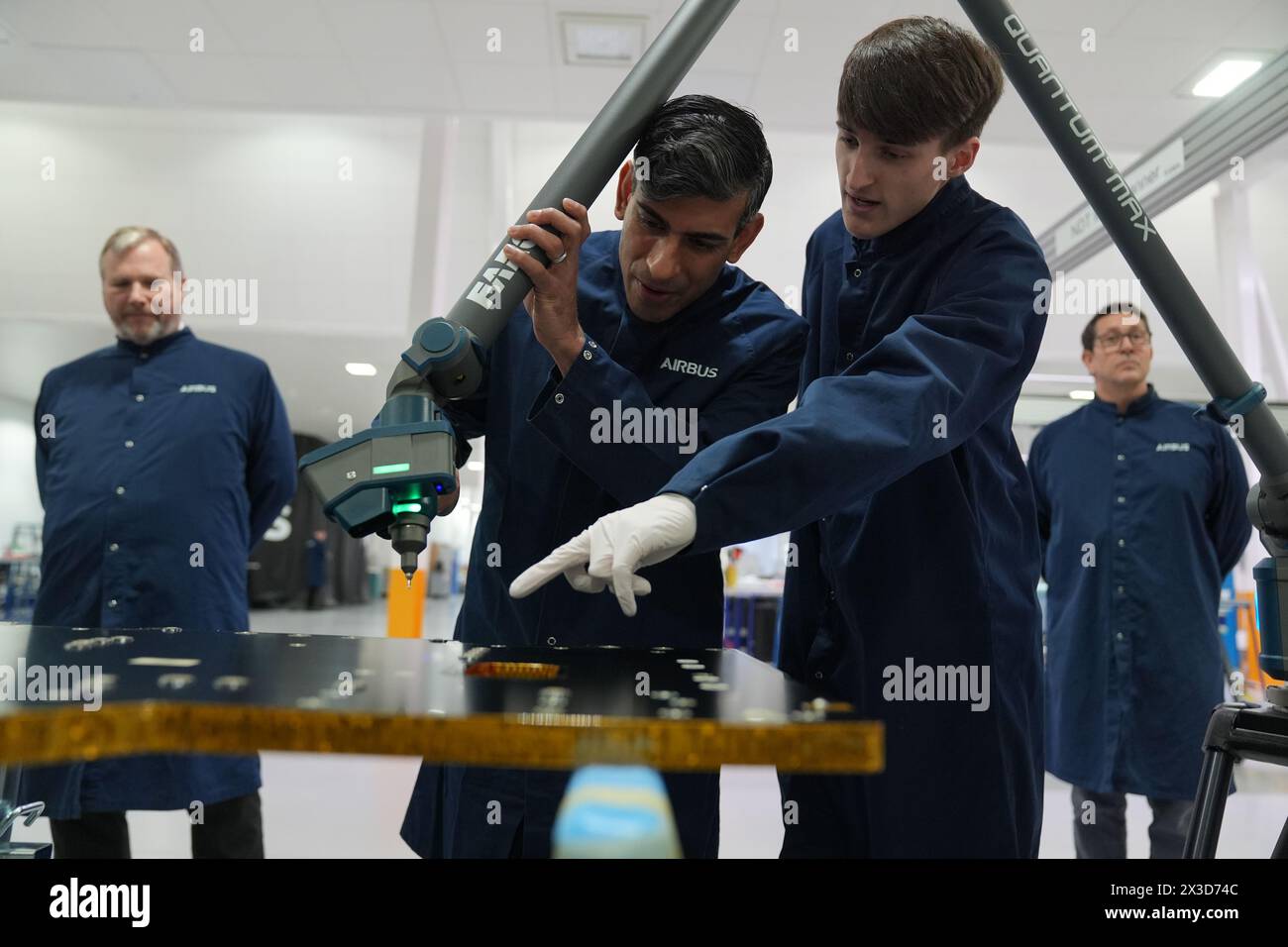 Prime Minister Rishi Sunak using machinery during a visit to the Airbus ...