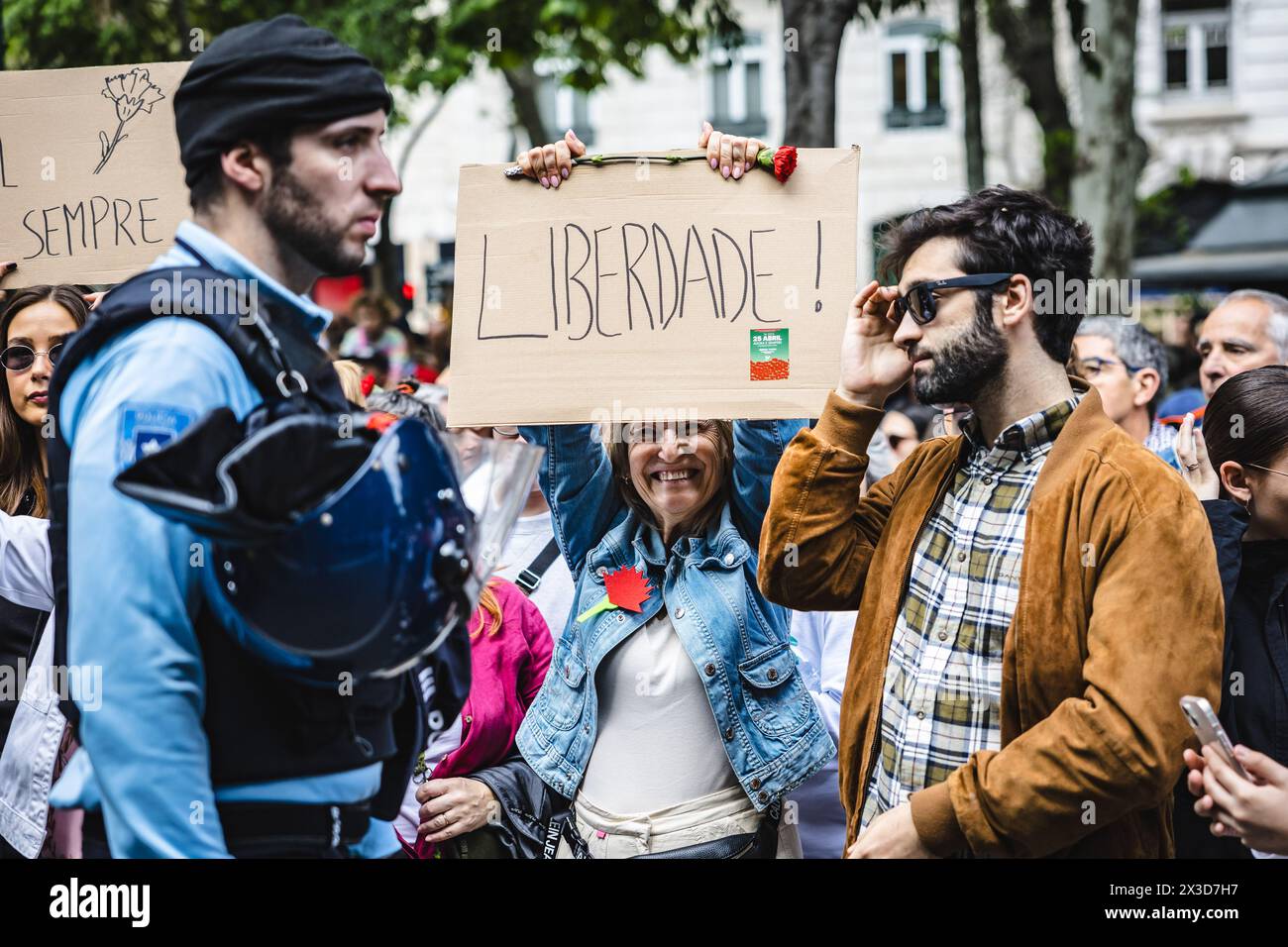 A woman holds a placard saying "freedom" during the parade in the ...
