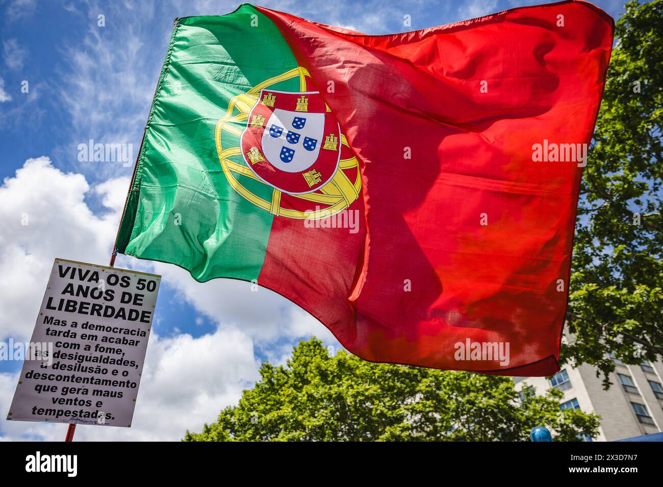 A flag of Portugal with a poster that says "Long live 50 years of ...