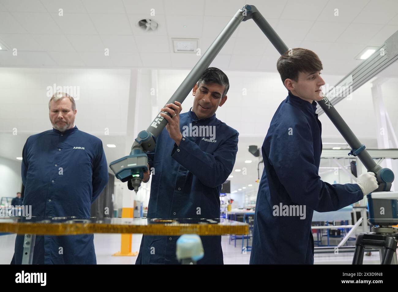 Prime Minister Rishi Sunak using machinery during a visit to the Airbus ...