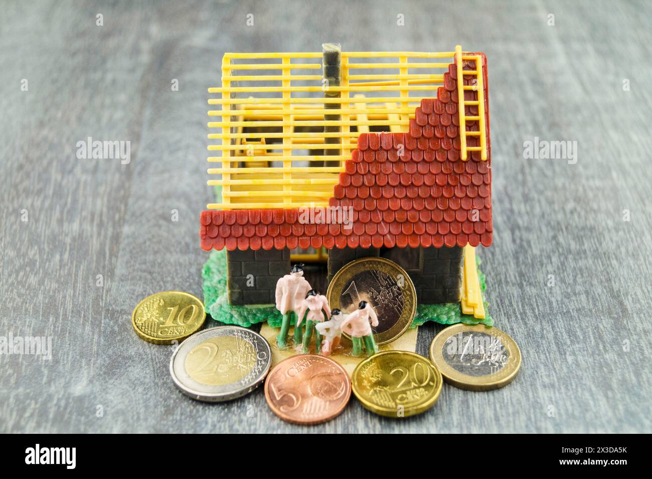 unfinished model house and Euro coins, symbolising the rise in house ...