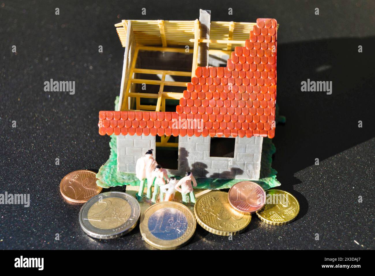 unfinished model house and Euro coins, symbolising the rise in house ...