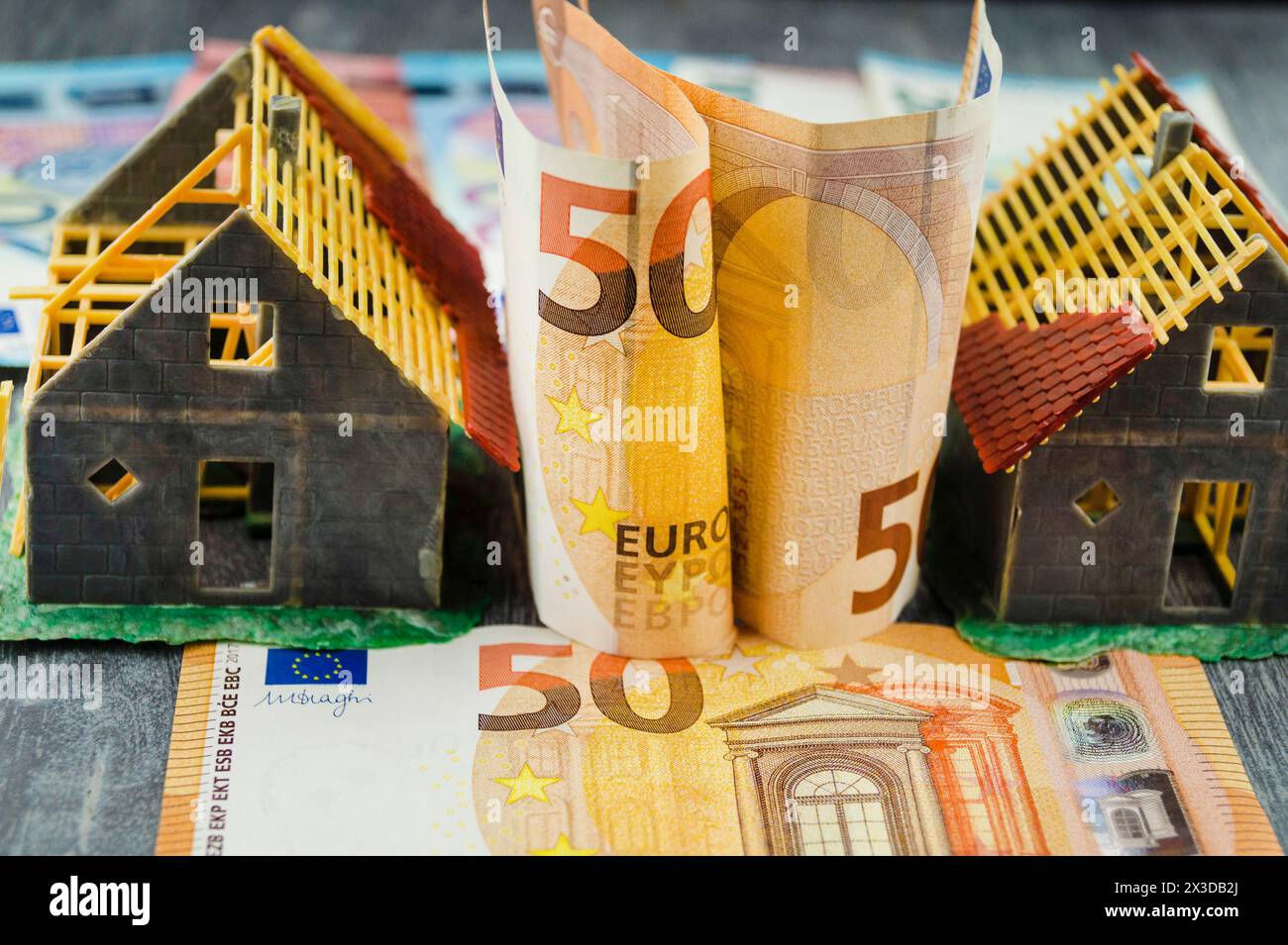 unfinished model houses on Euro coins, symbolising the rise in house ...