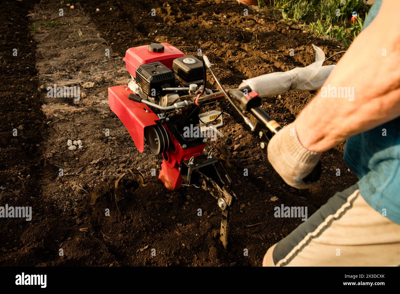 a tillerblock plows the land in the garden. A tillerblock for plowing ...
