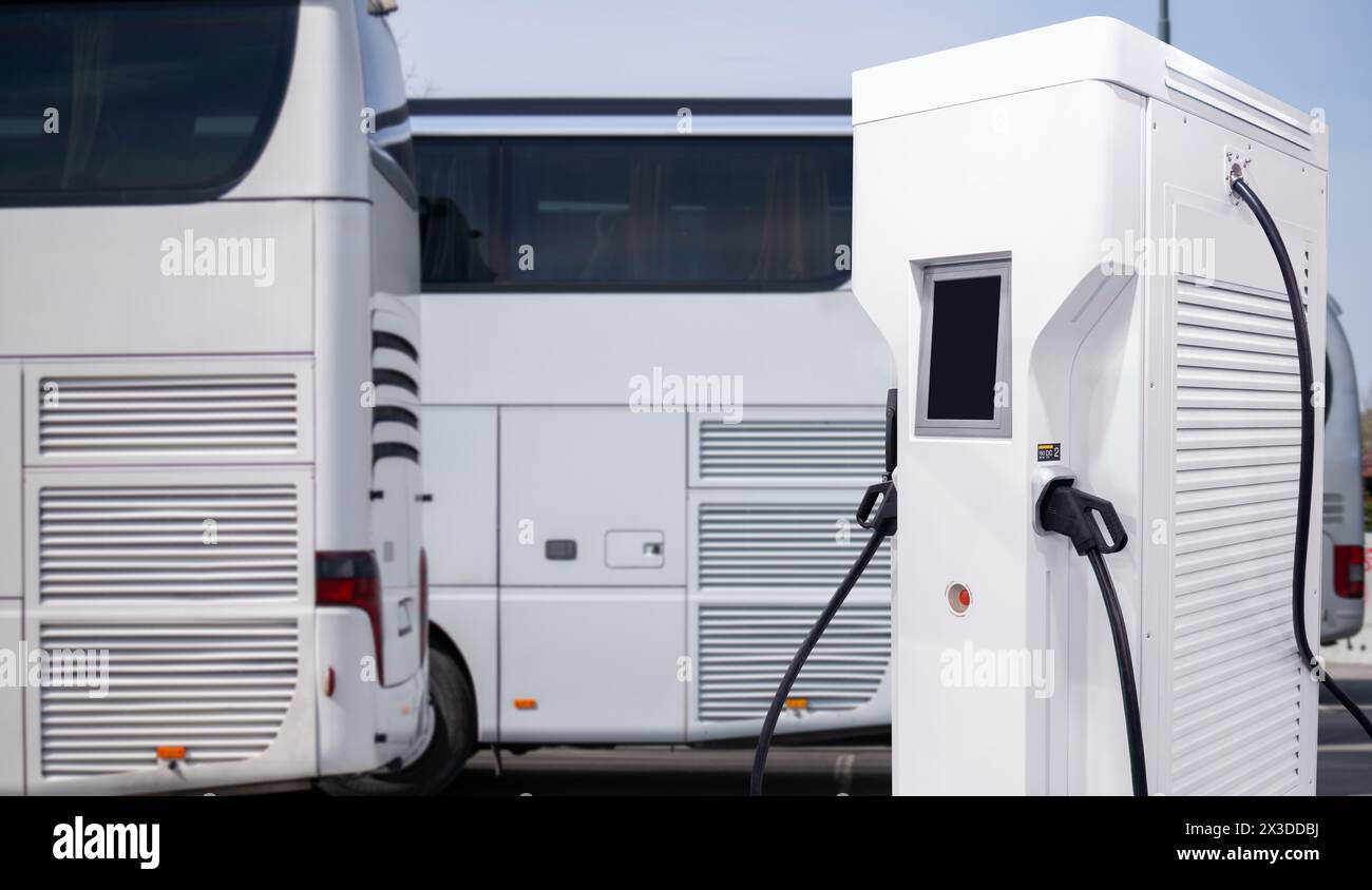 Electric buses with charging station Stock Photo - Alamy