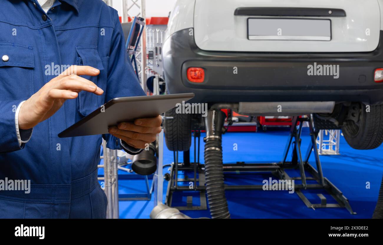 Serviceman with digital tablet on the background of the car in the car ...