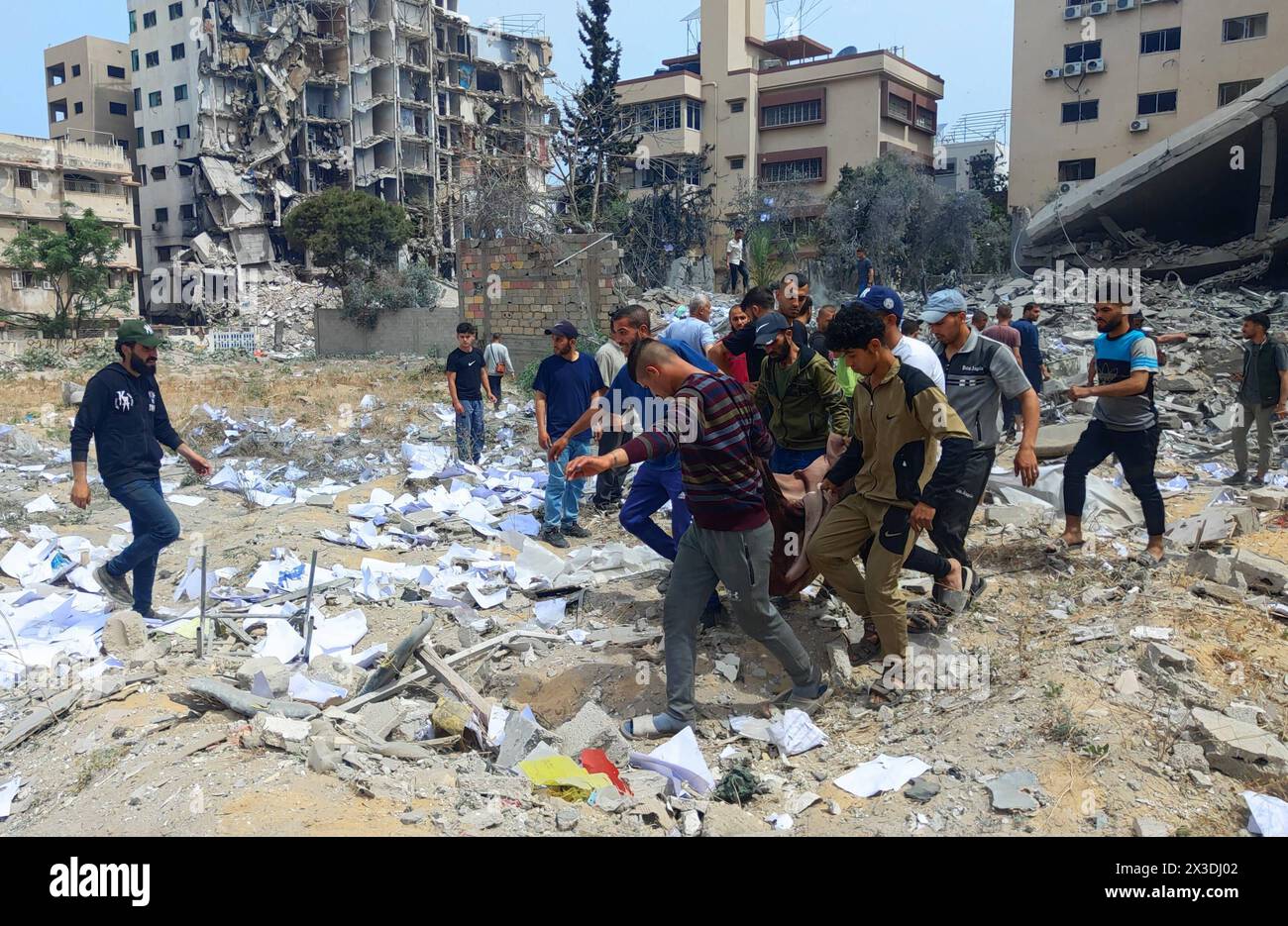 Palestinian residents living in the area inspect the destroyed house ...