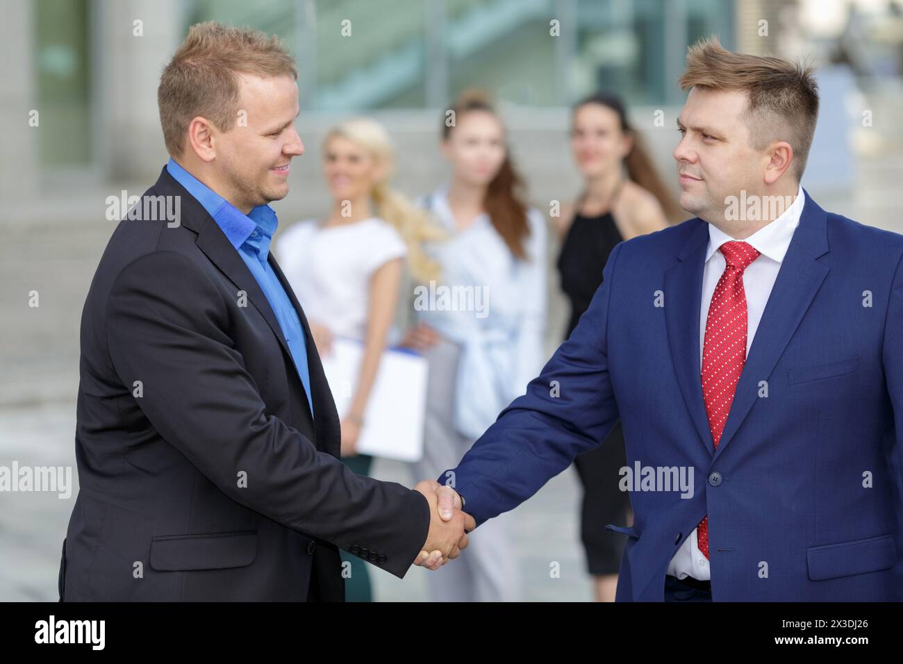 two confident and motivated business partners at work, both are shaking ...