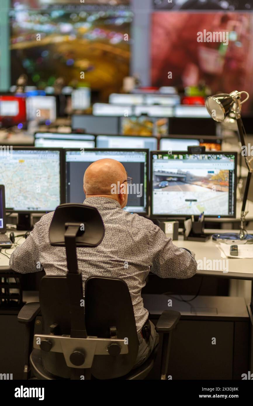 operator sitting at monitor in office room for passenger traffic ...