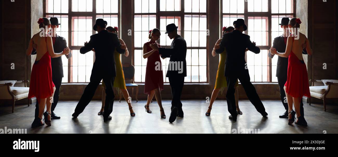 woman in red dress and man in black suit dance tango near window ...