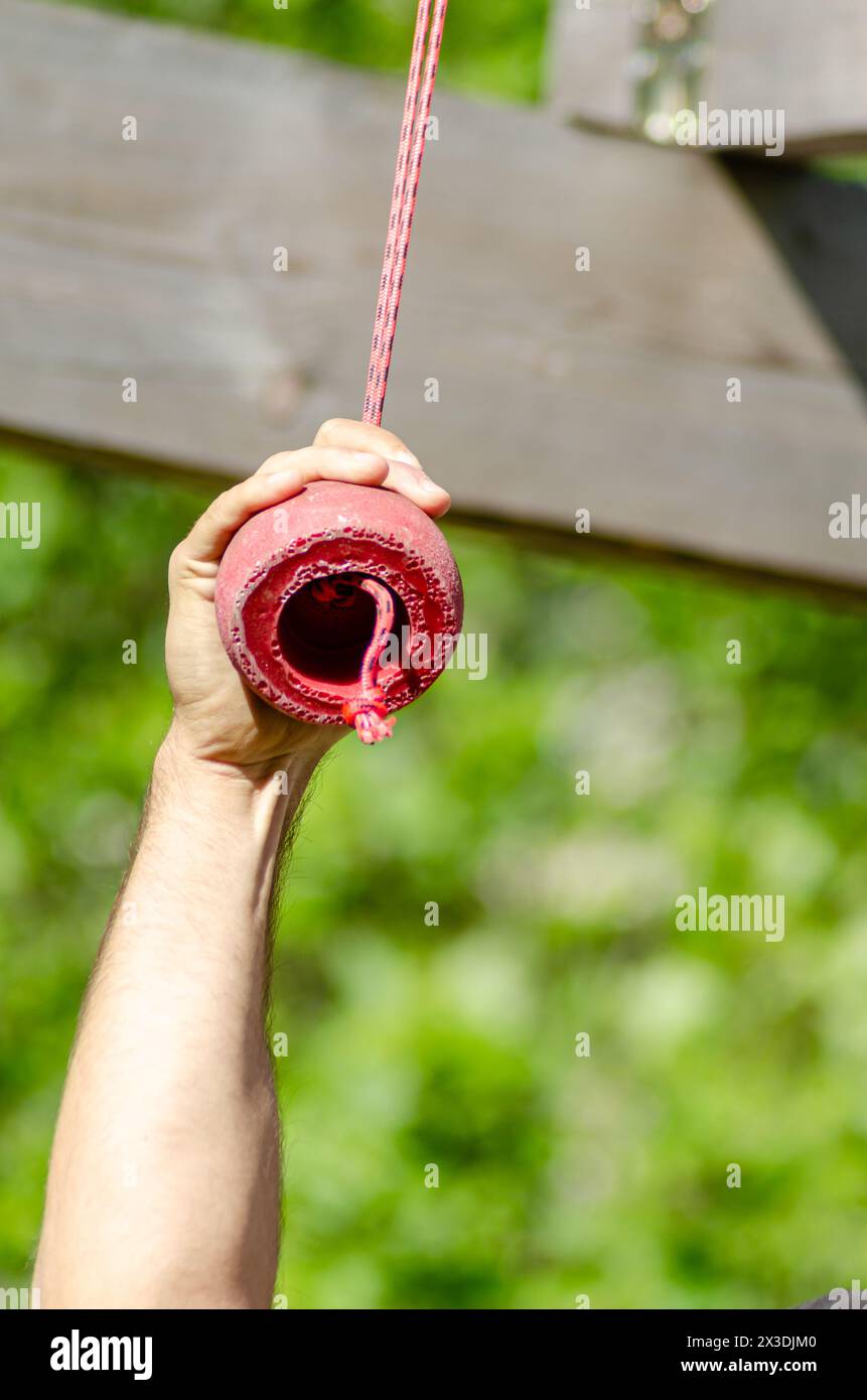 Detail of an athlete hand at a hanging obstacle at an obstacle course ...