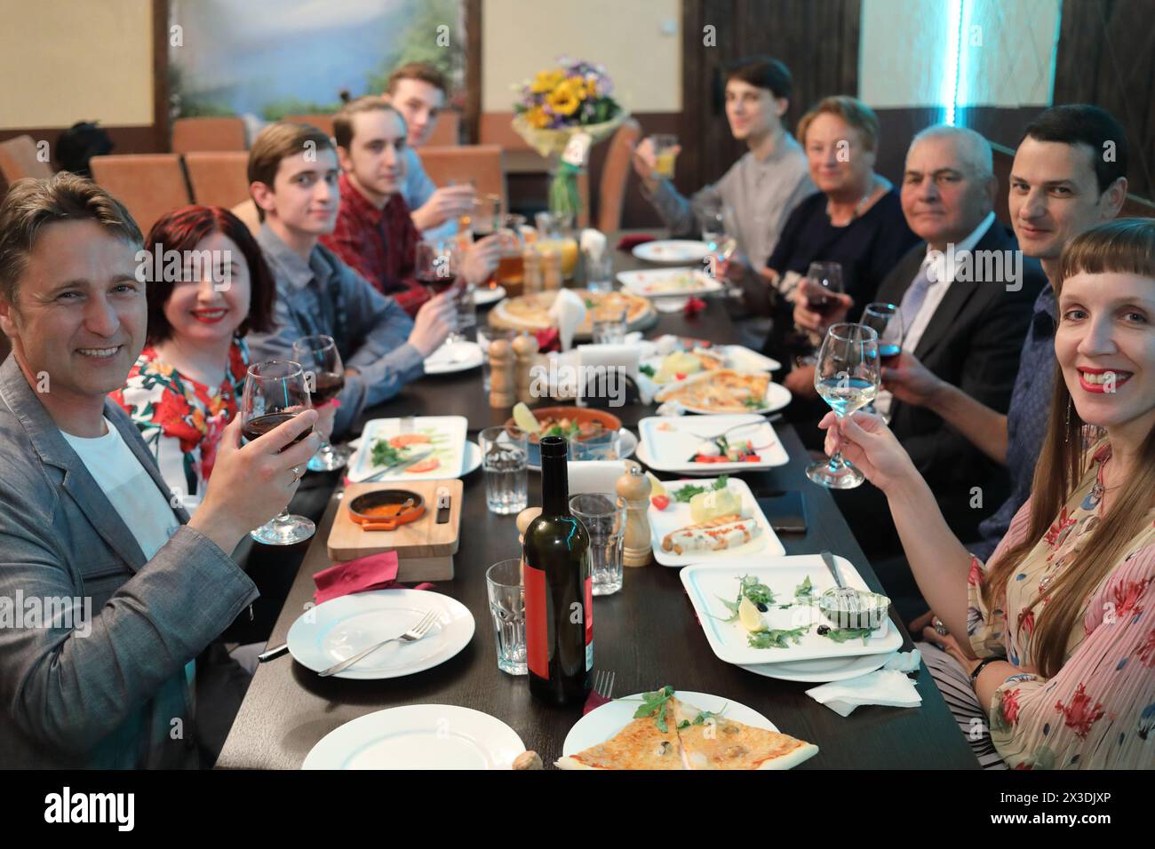 family feast, relatives (with model releases) sit together at table ...
