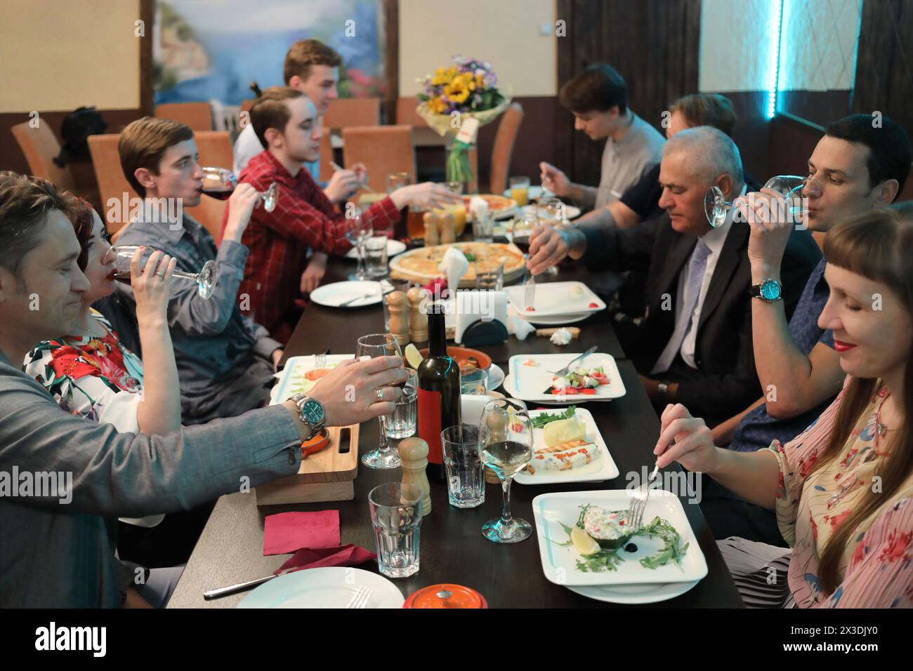 family feast, relatives (with model releases) sit together at table ...