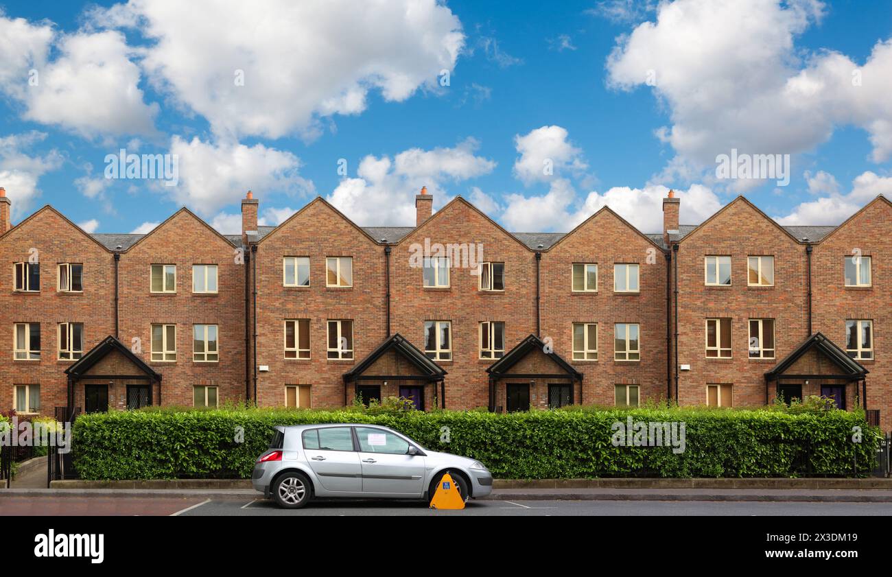 collage with small three-story house stands beside road. windows, high ...