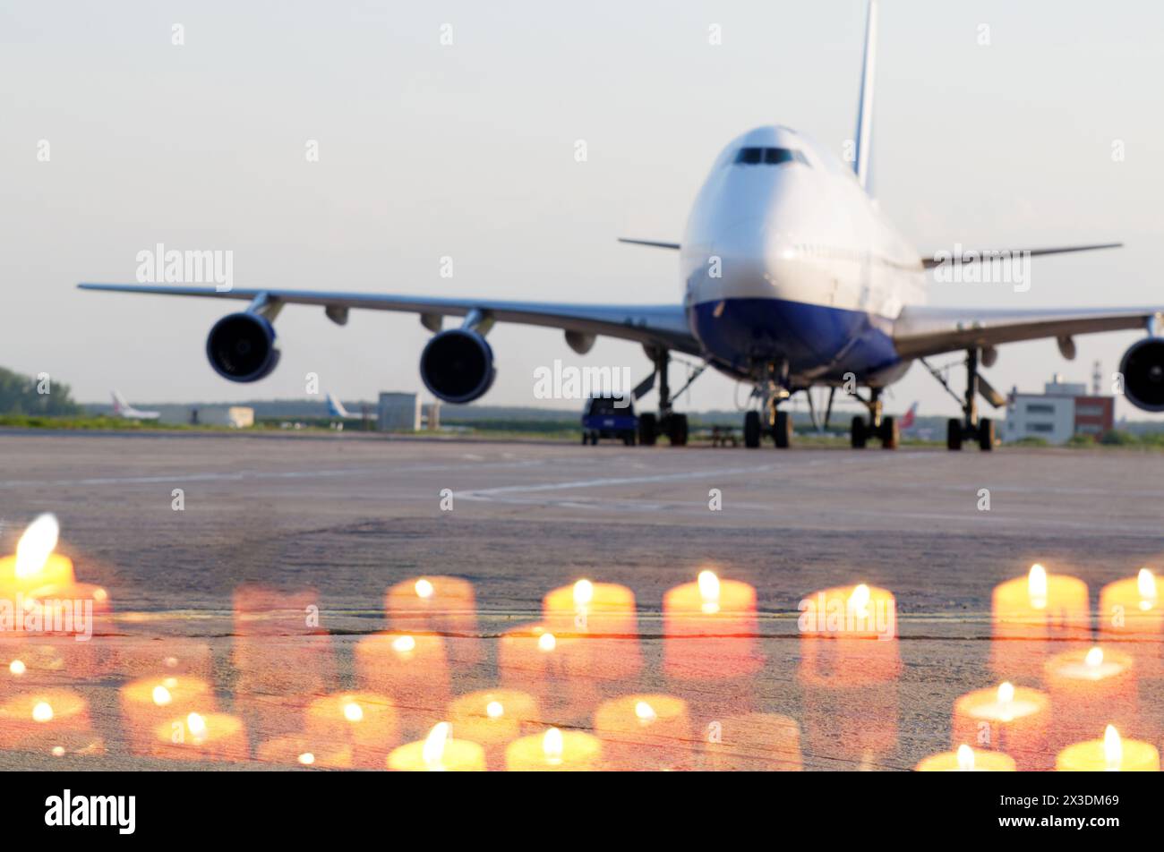 Collage with big jetplane parked at airport and burning candles, memory ...