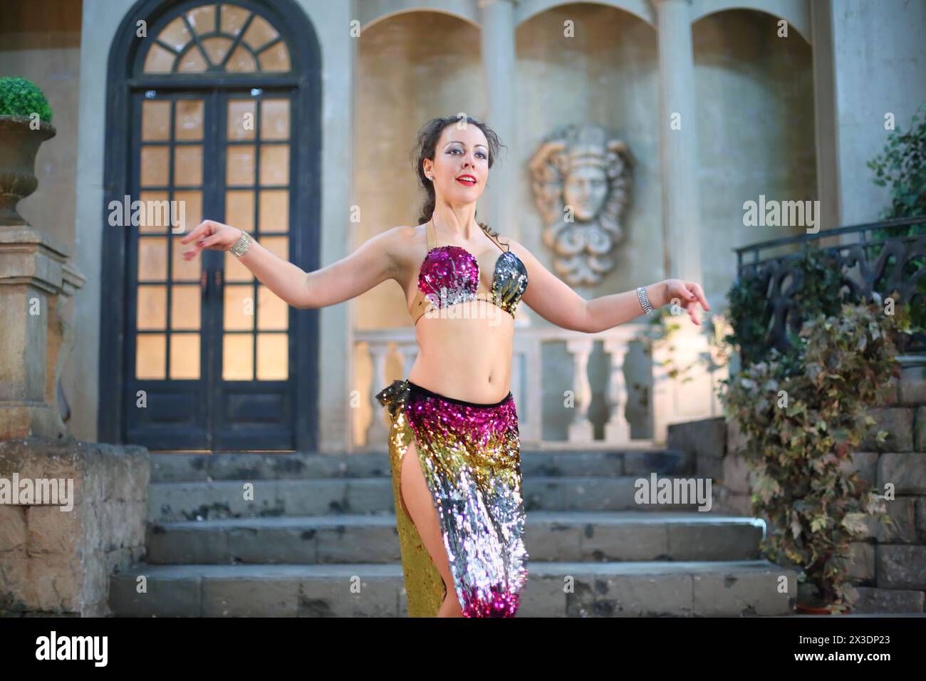 Portrait of beautiful woman in shiny suit decorated with pearls is dancing Arabic dance Stock ...