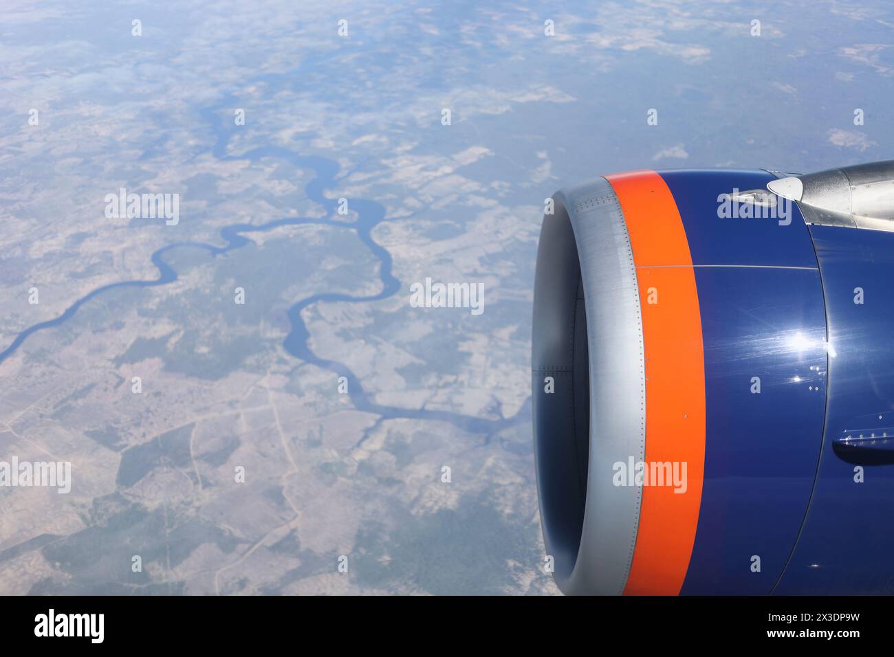 The aircraft engine in front of the landscape of the earth during the ...