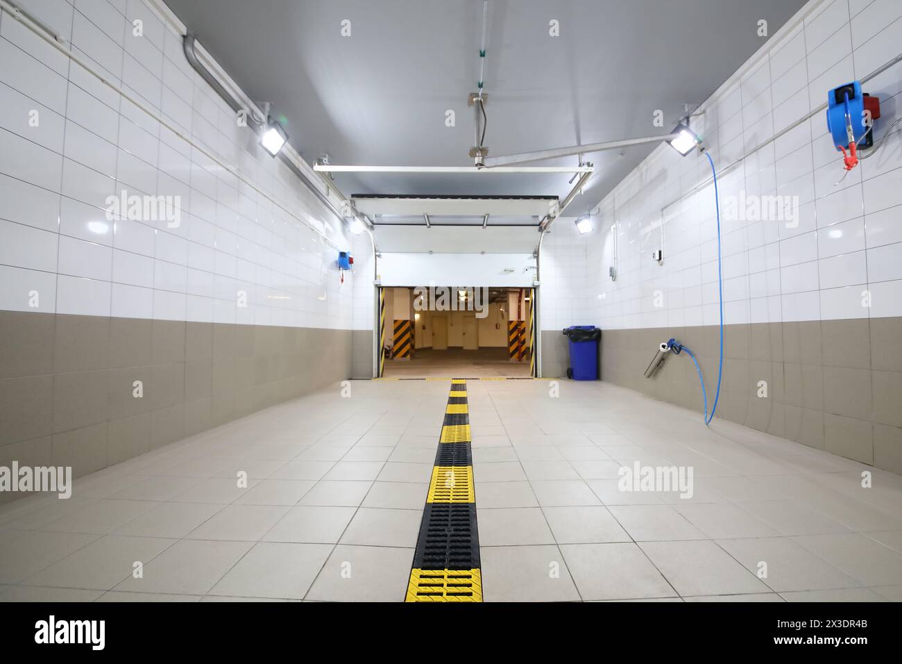 Empty clean car wash room with drainage device and open lifting gate ...