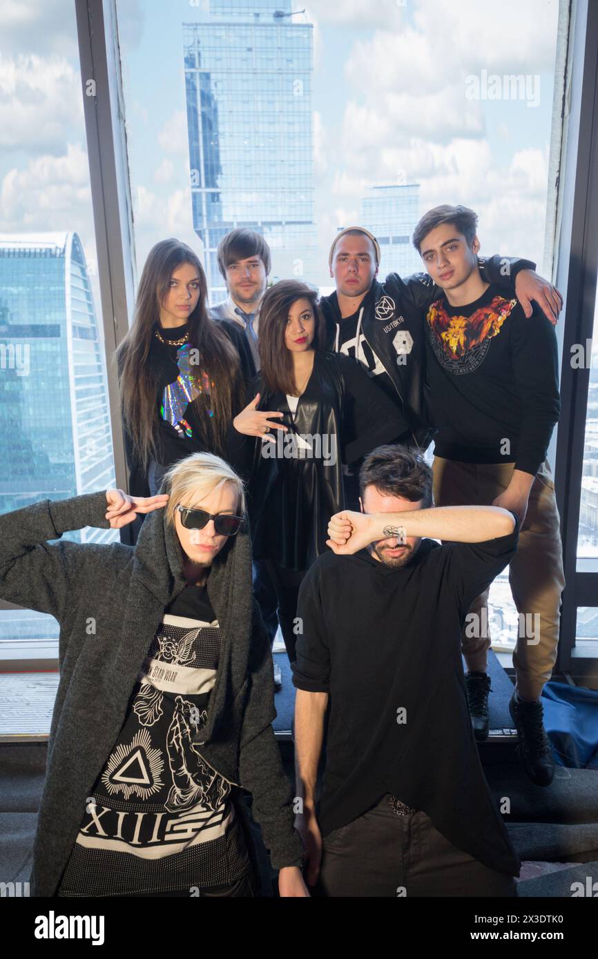Group of seven people in black are standing near big window Stock Photo ...