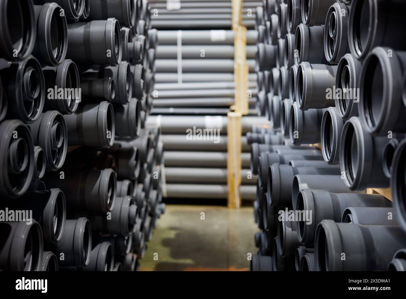 Plenty of gray plastic pipes at indoor storage, shallow dof Stock Photo ...