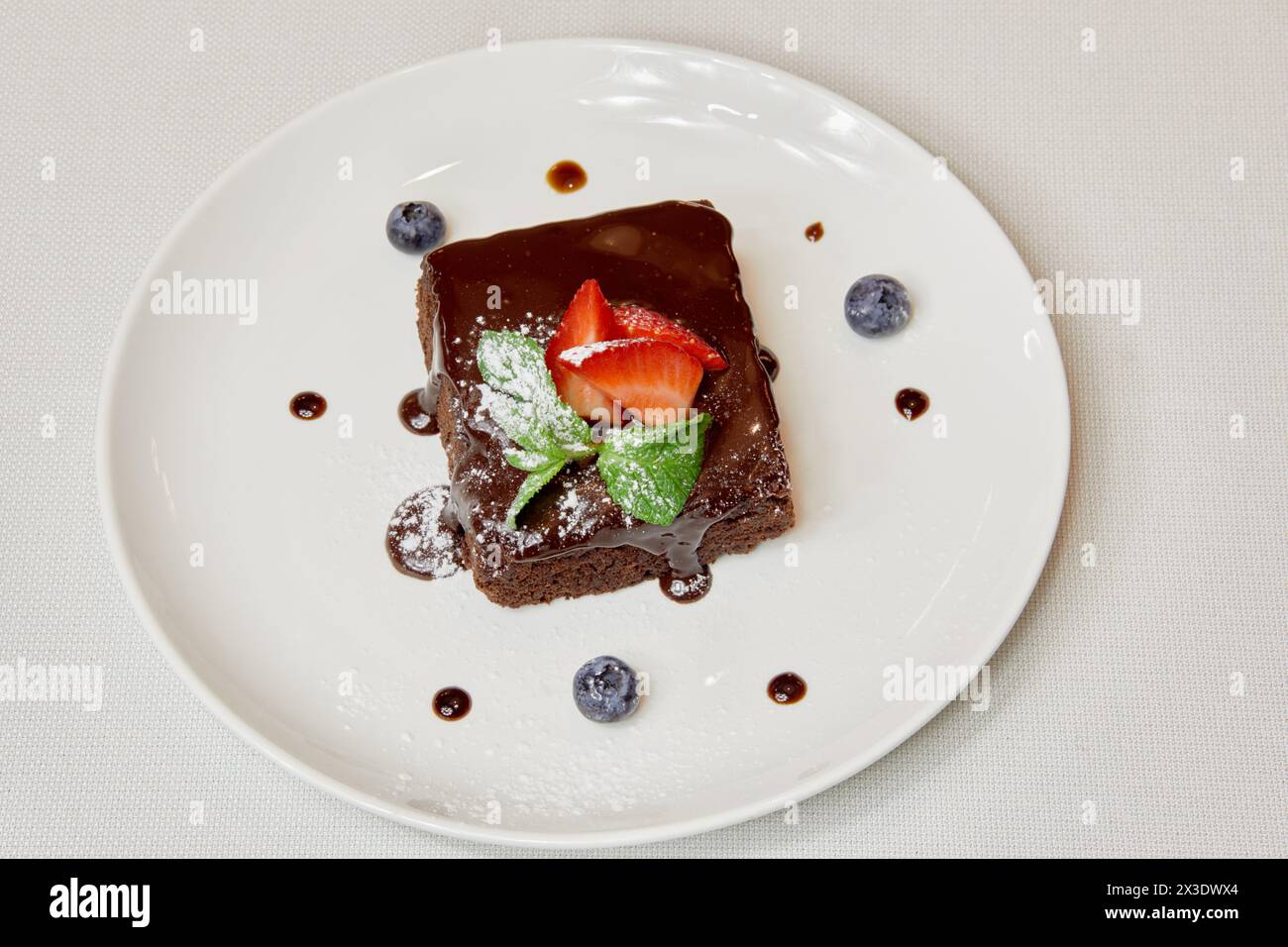 Chocolate sponge cake with strawberry, mint and blueberry Stock Photo ...