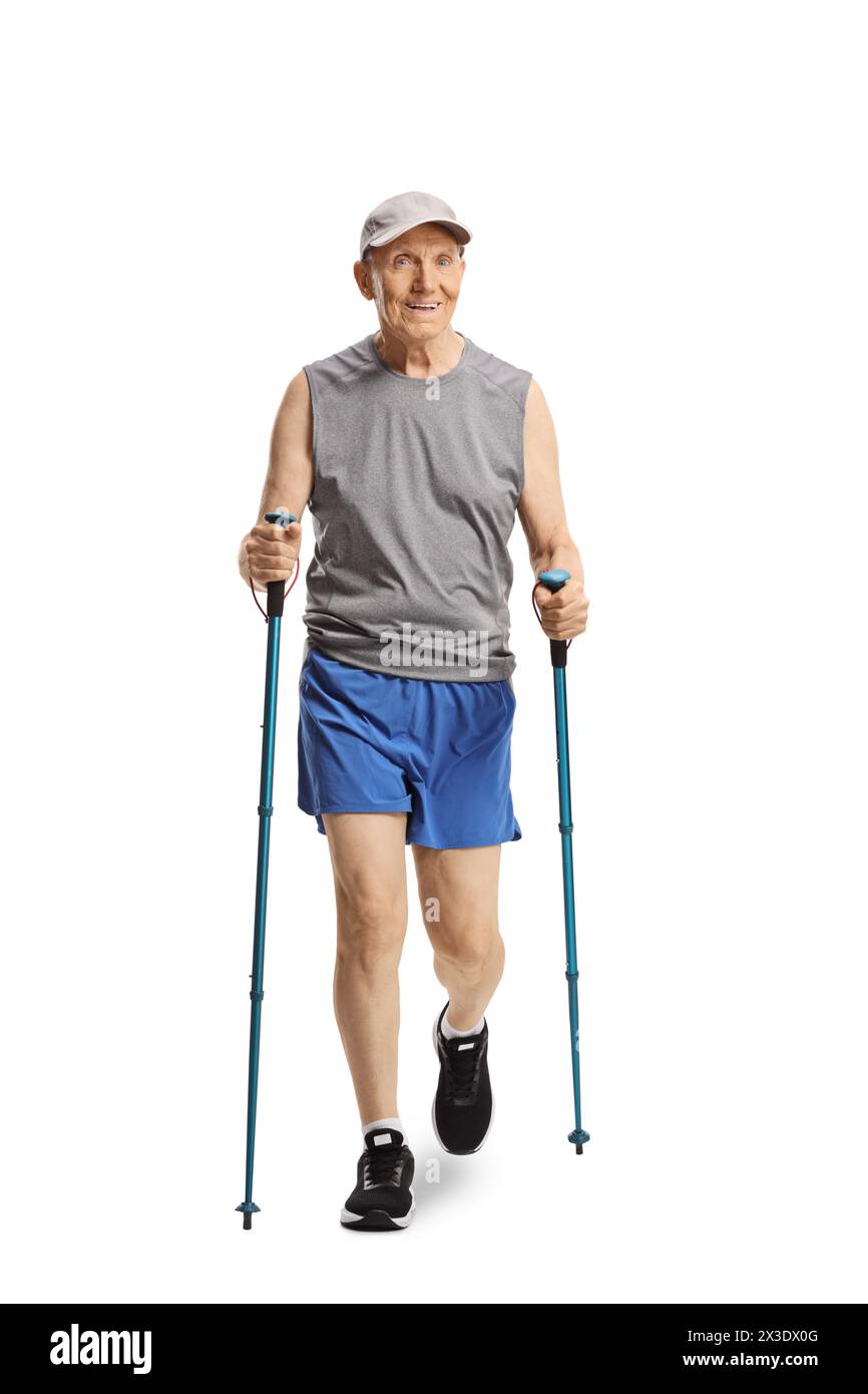 Elderly man in sportswear walking with trekking poles isolated on white ...