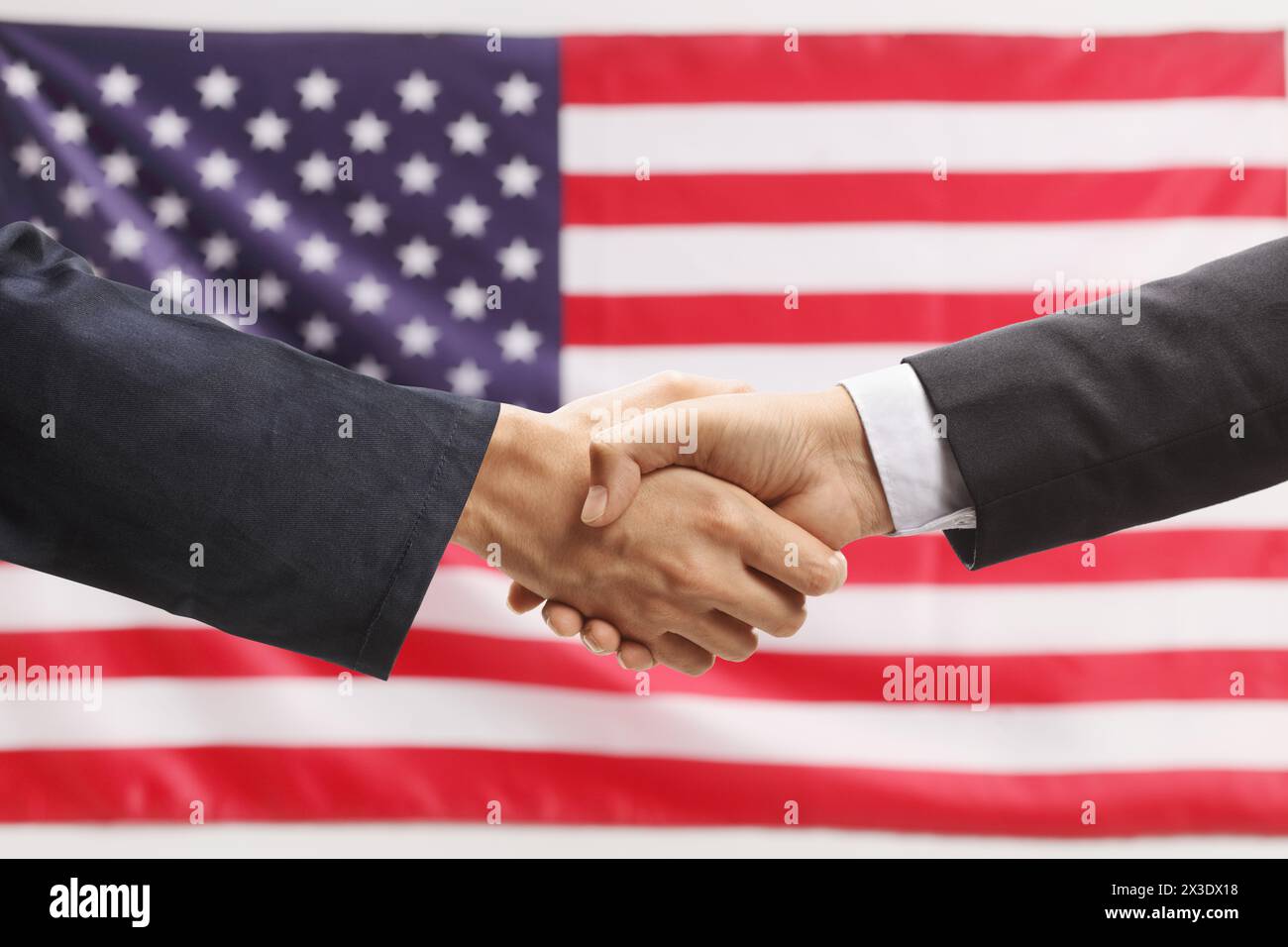 Men shaking hands in front of a USA flag Stock Photo - Alamy