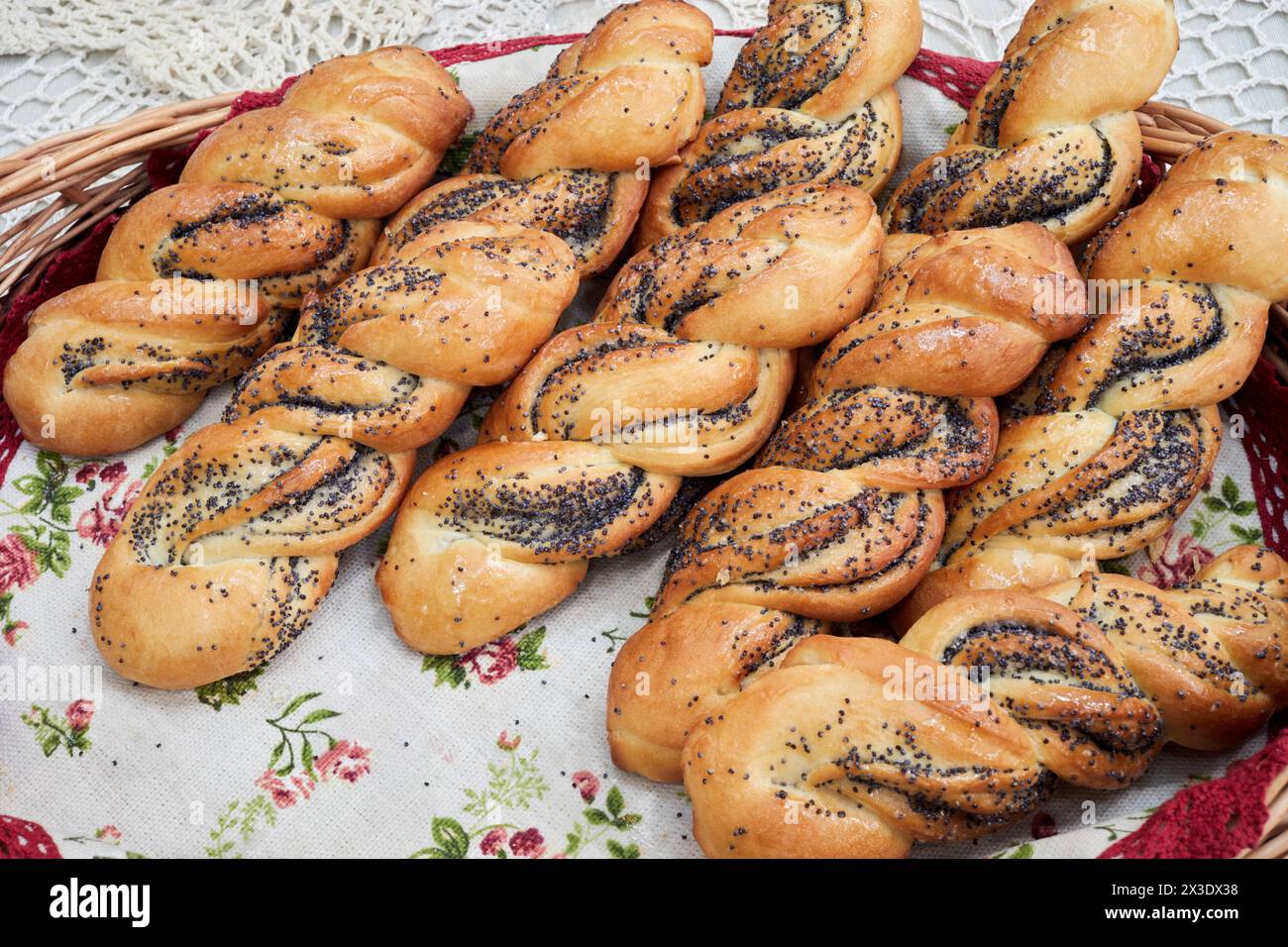 Roll cakes with poppy seed in wicker basket Stock Photo - Alamy