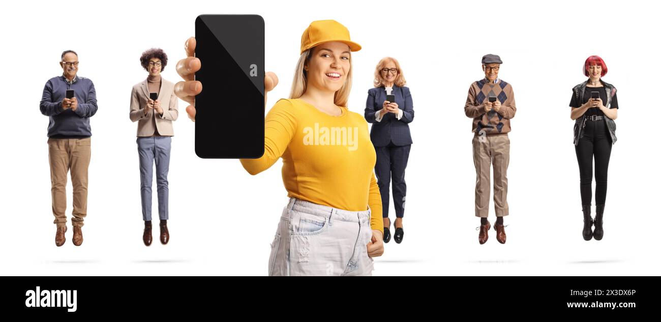 Group of excited mobile phone users jumping, young female showing a ...