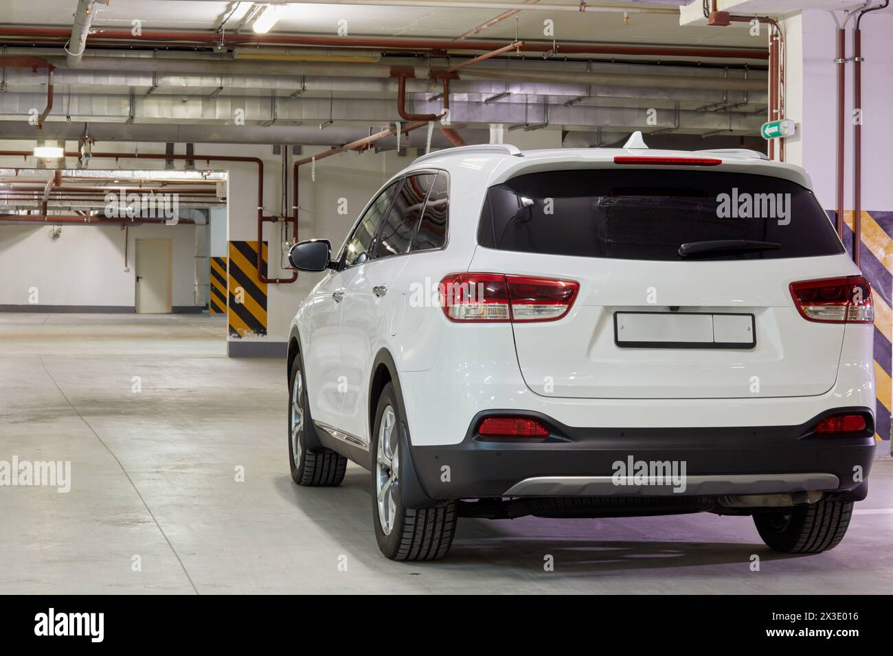 New white car at underground parking, rear view Stock Photo - Alamy