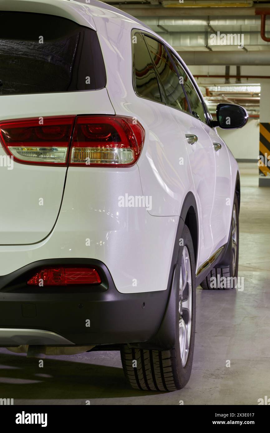 Right side of white car at underground parking, rear view Stock Photo ...