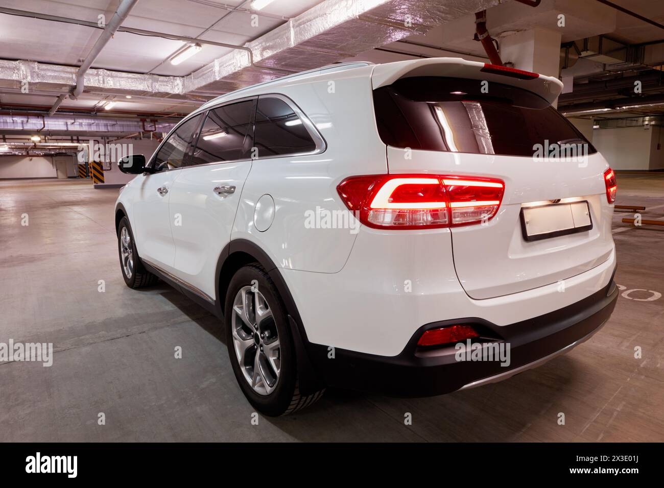 White car with tail lights on at underground parking, rear view Stock ...
