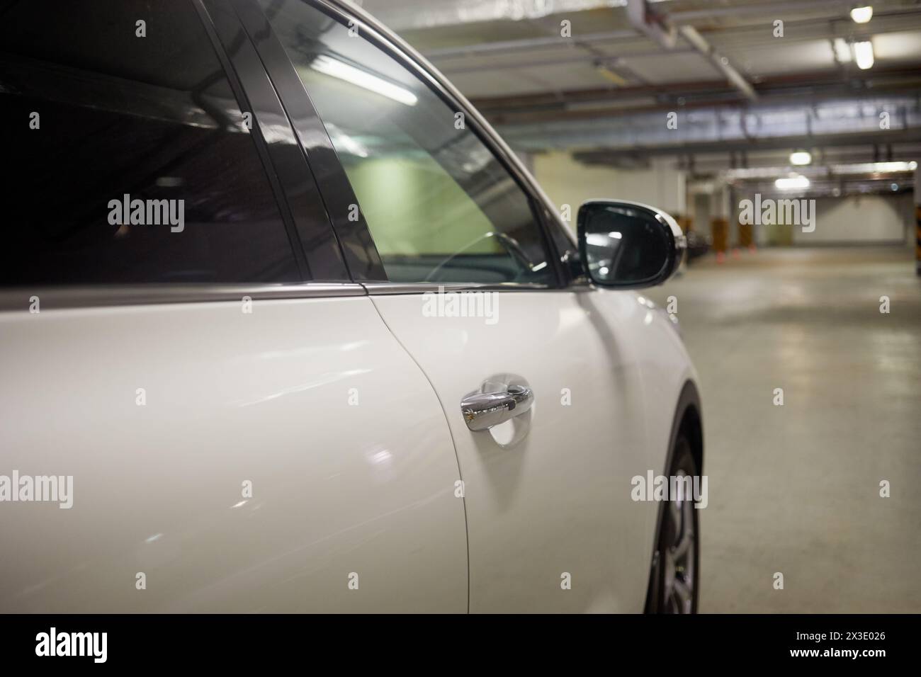 Side of white modern car at underground parking, side rear view Stock ...