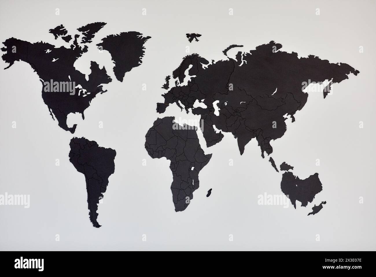 Dark grey world map on wall Stock Photo - Alamy
