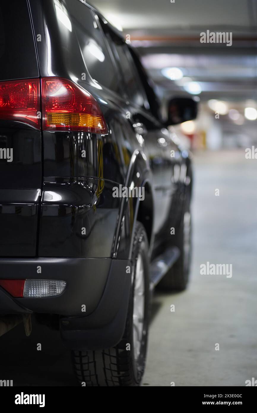 Right side of black car at underground parking, rear side view Stock ...