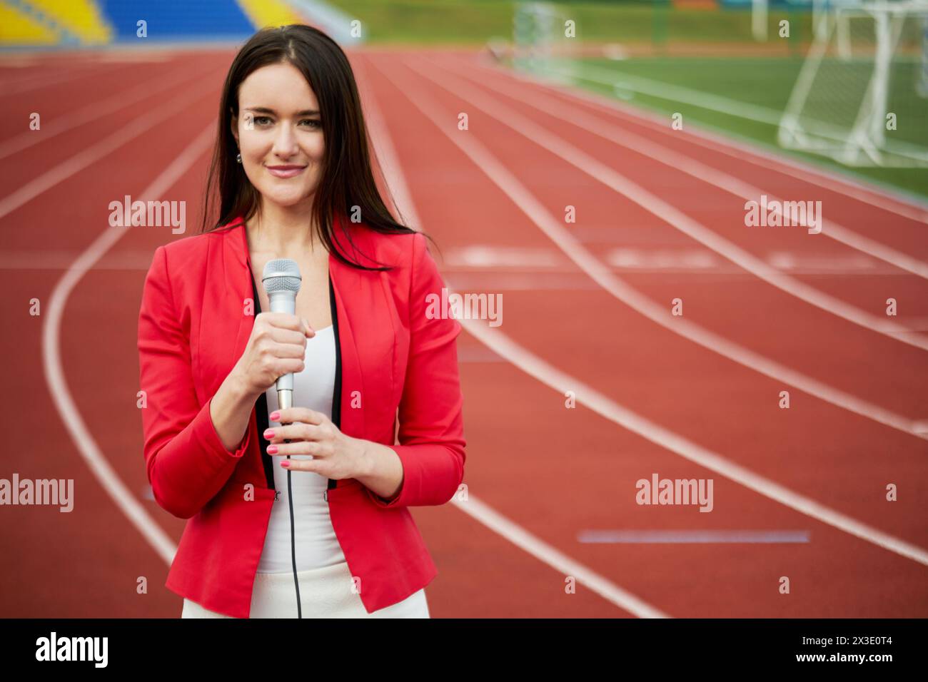Young smiling woman journalist reports from stadium Stock Photo - Alamy