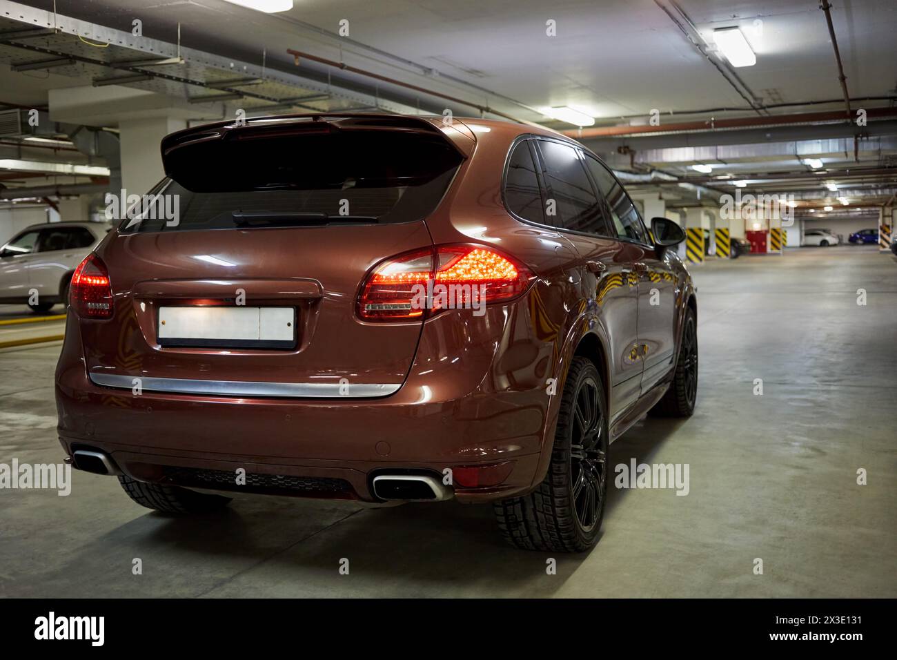 New modern car at underground parking, rear right side view Stock Photo ...
