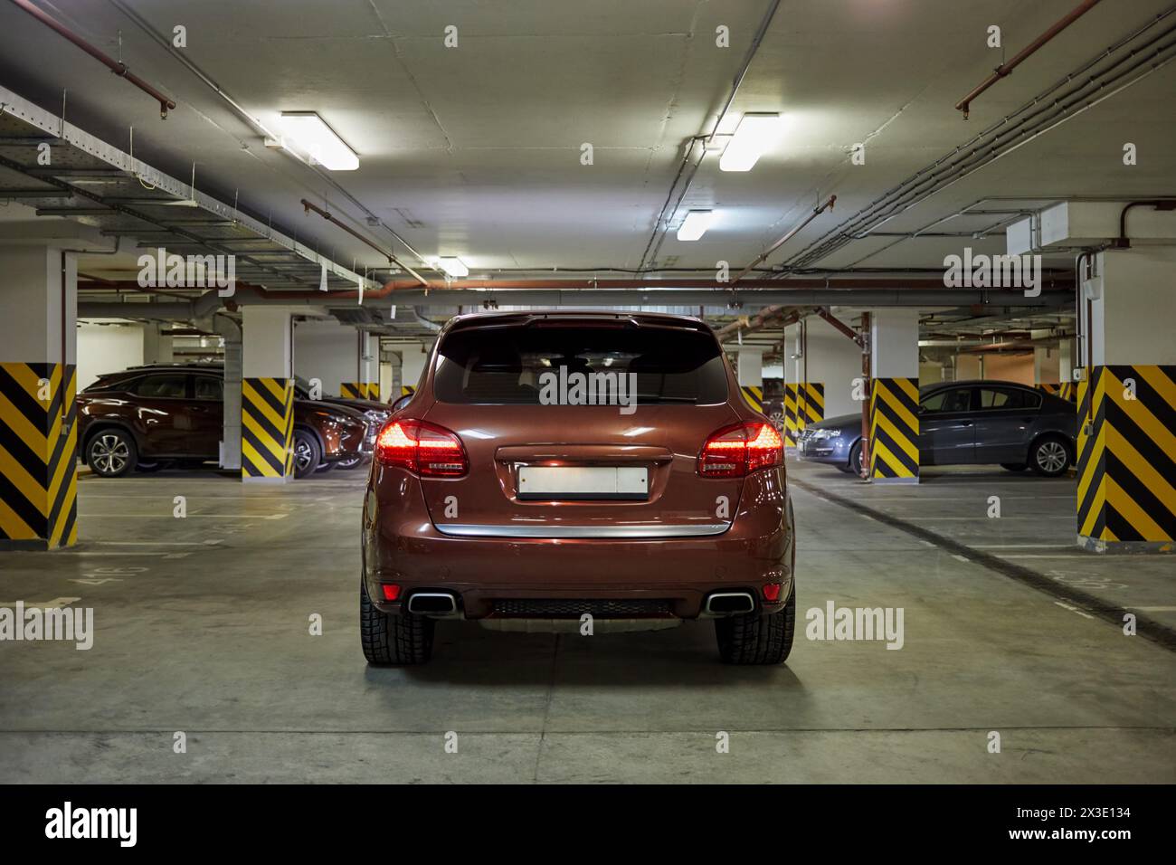New modern car at underground parking, rear view Stock Photo - Alamy