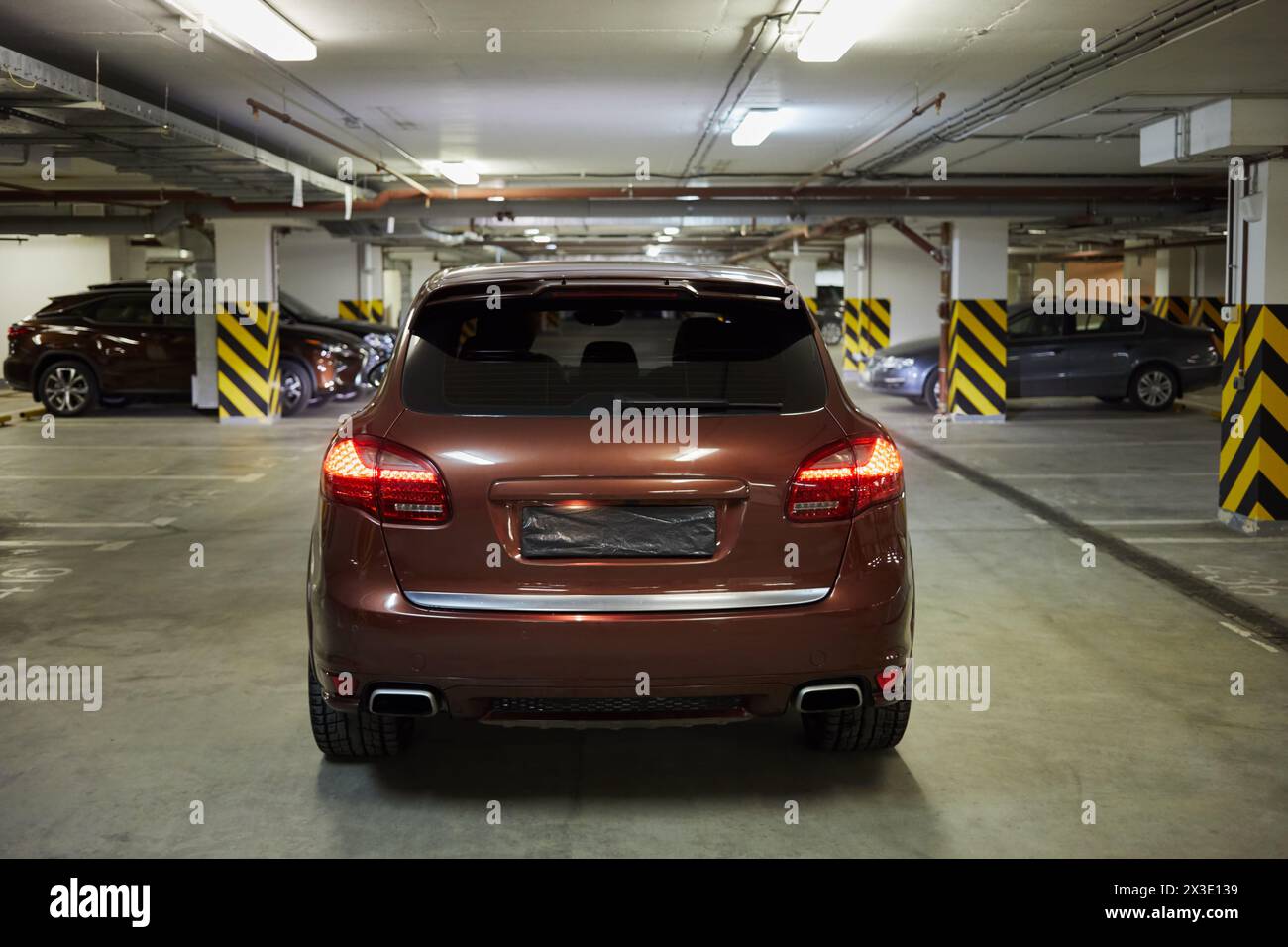 Rear view of new modern car at underground parking Stock Photo - Alamy